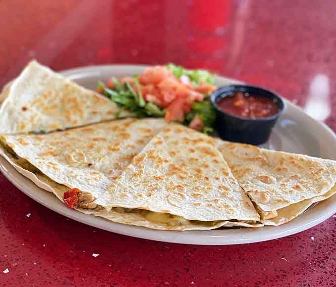 Grilled to perfection and stuffed with goodness, this quesadilla proves fusion worked better in the kitchen than music.