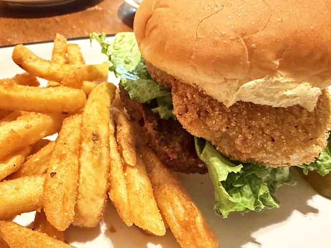That golden fried green tomato burger with crispy fries proves Kentucky knows how to elevate Southern classics beautifully.