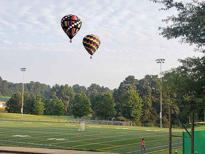 Two balloons drifting over the athletic fields remind us that the best seats in town aren't in the bleachers.