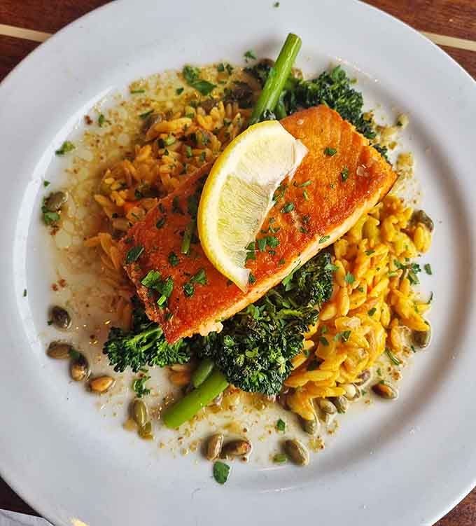 Perfectly seared salmon sitting pretty on a bed of greens is what dinner dreams are made of.
