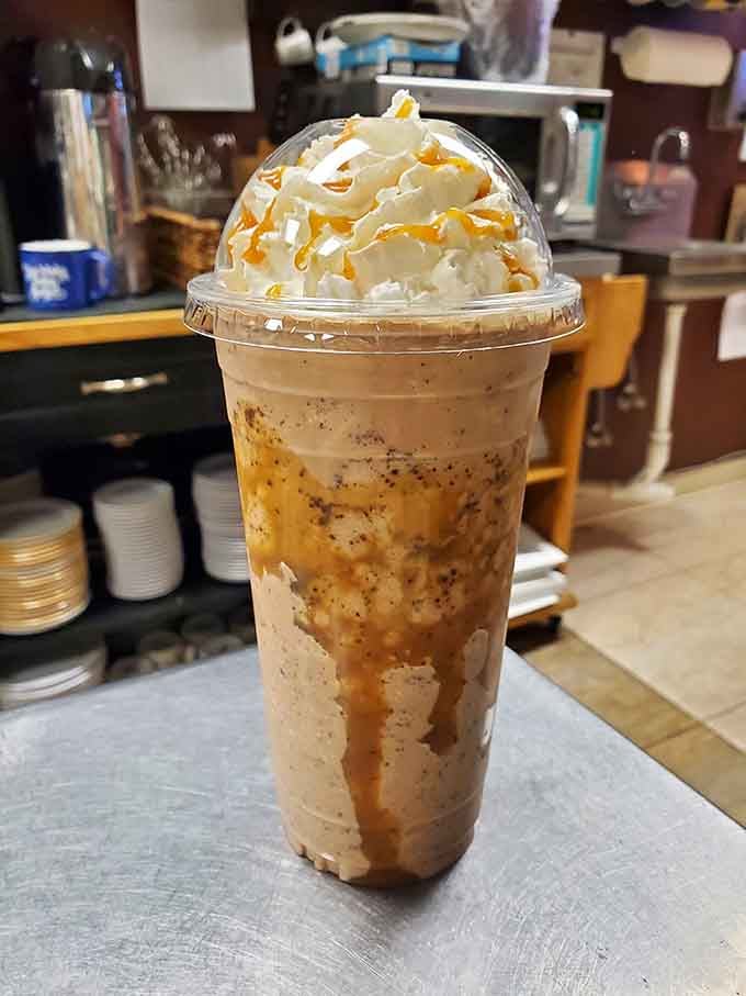 Whipped cream mountains topped with caramel drizzle, because sometimes adulting means ordering dessert disguised as coffee.