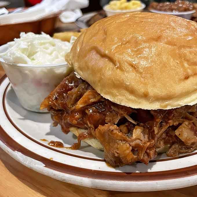 Pulled pork piled high on a buttery bun, this sandwich means business and delivers satisfaction.