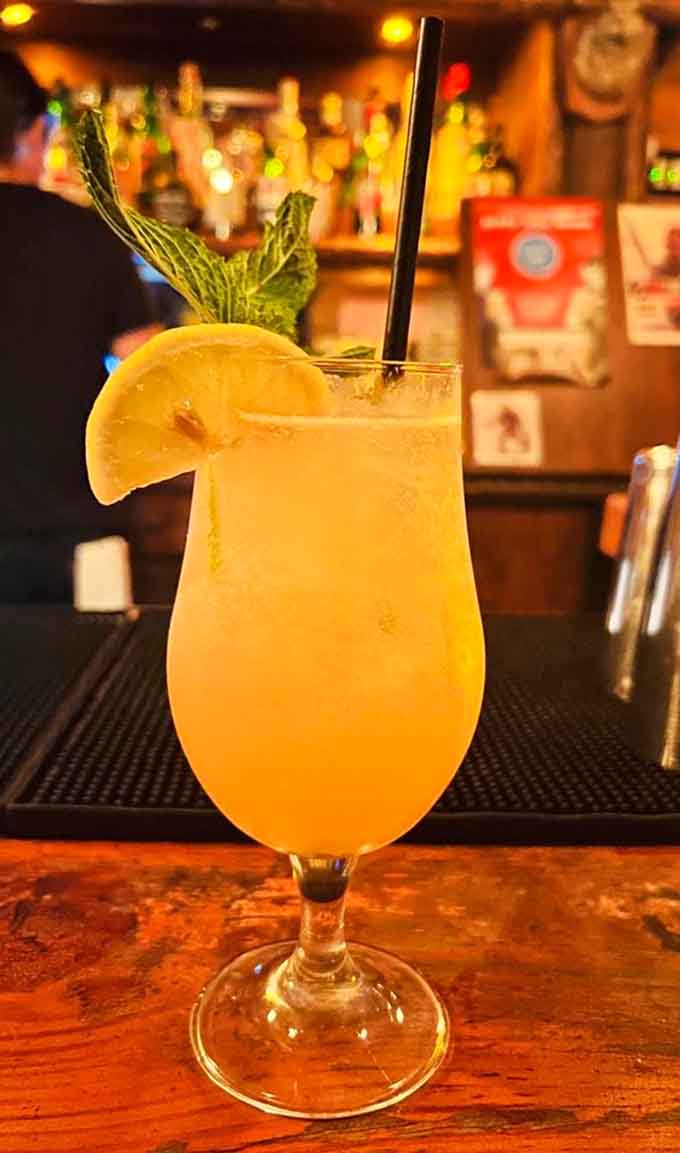 That pineapple garnish is working harder than most people on a Monday, making this tropical drink absolutely Instagram-worthy.