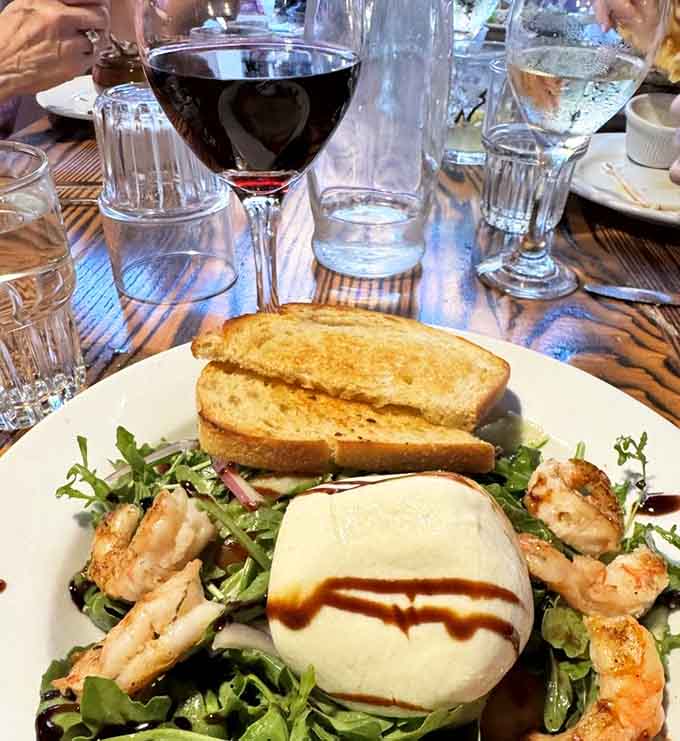 Fresh burrata meets perfectly grilled shrimp on a bed of greens, because even haunted pubs understand the importance of balance.