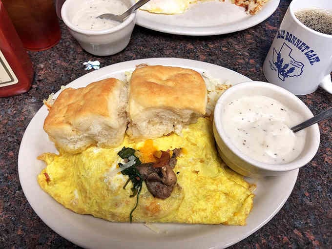 That fluffy omelet with a side of gravy-smothered biscuit proves breakfast should never be a small affair.