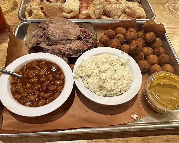Fried chicken, pulled pork, beans, and slaw on one tray &ndash; it's like Thanksgiving decided to go Southern and casual.
