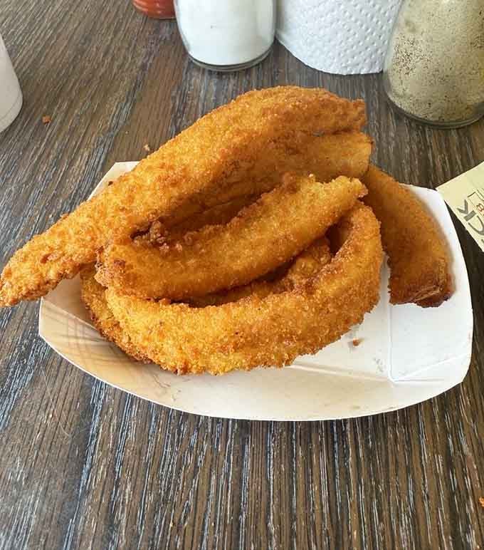 Golden onion rings so perfectly crispy they could double as edible jewelry for your taste buds.