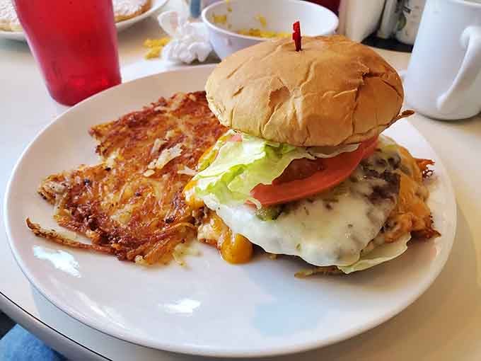 This burger comes with crispy hash browns and enough toppings to require an engineering degree to eat it properly.