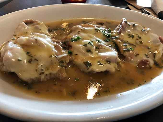 Chicken Marsala bathes in wine-infused sauce, proving simple ingredients can create extraordinary flavor when done right.