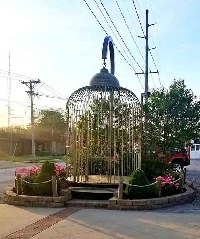 An enormous birdcage sits empty, waiting perhaps for a pterodactyl or someone with very ambitious pet-keeping dreams.