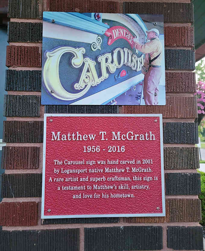 A hand-carved sign honoring the craftsman who kept the carousel's artistic legacy alive for future generations.