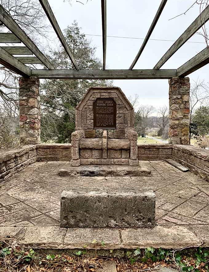 This historic memorial chair sits beneath a pergola, offering a place to pause and reflect on stories past.