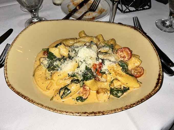 Rigatoni swimming in creamy sauce with fresh tomatoes and greens, because sometimes pasta needs to show off a little.