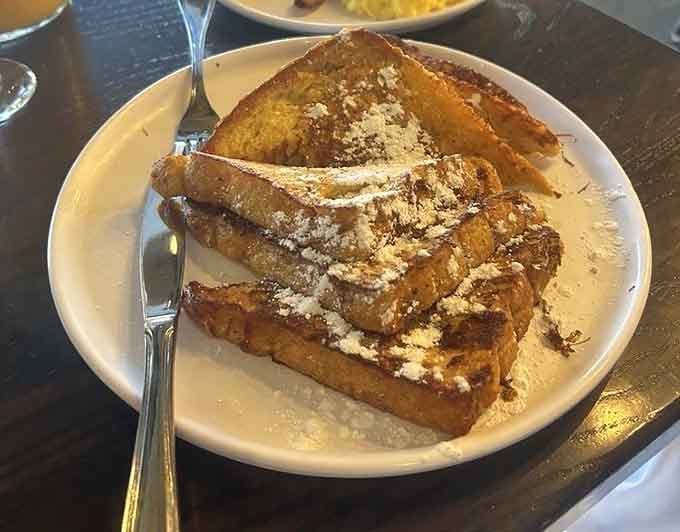 Thick slices of buttery brioche transformed into French toast that would make Julia Child smile with pure delight.