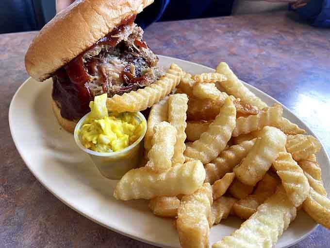 Pulled pork piled high on a bun with crinkle fries&mdash;this is what comfort looks like on a plate.