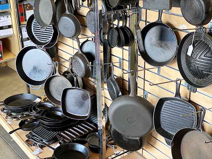 Cast iron cookware hanging like culinary trophies, ready to outlast your grandchildren's grandchildren and then some.