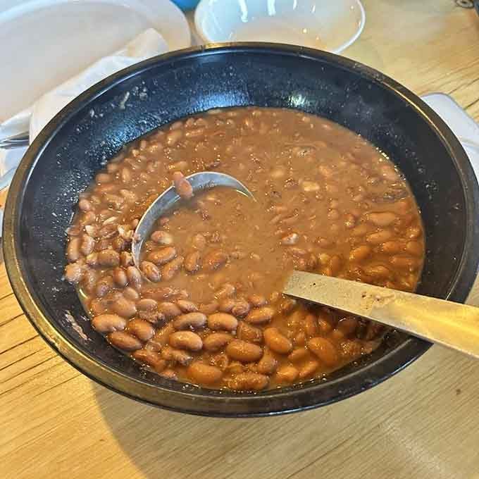 Hearty beans simmering in a cast-iron pot, the kind of comfort food that's warmed cowboys for generations on cold nights.