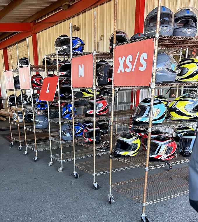 Helmets organized by size ensure everyone gets proper gear, because safety is the ultimate racing accessory.