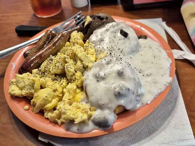 Biscuits drowning in gravy next to scrambled eggs: breakfast done the way your appetite has been dreaming about.