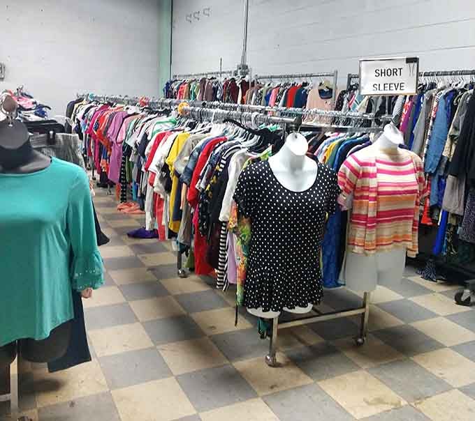 Racks stretching into the distance like a fabric rainbow, organized by sleeve length for your convenience.