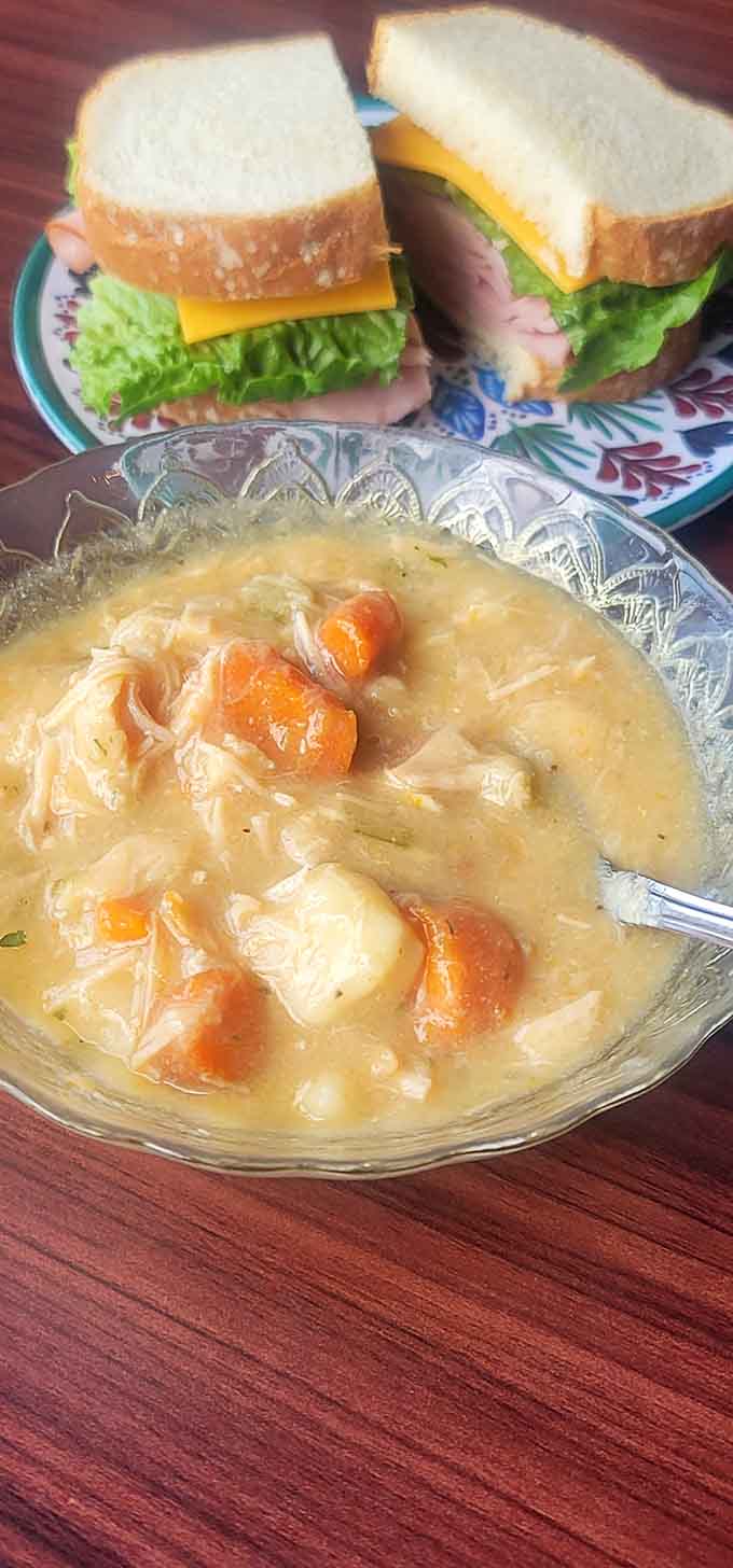 Chicken dumplings swimming in broth alongside a classic sandwich&mdash;comfort food that doesn't require a quest to enjoy.