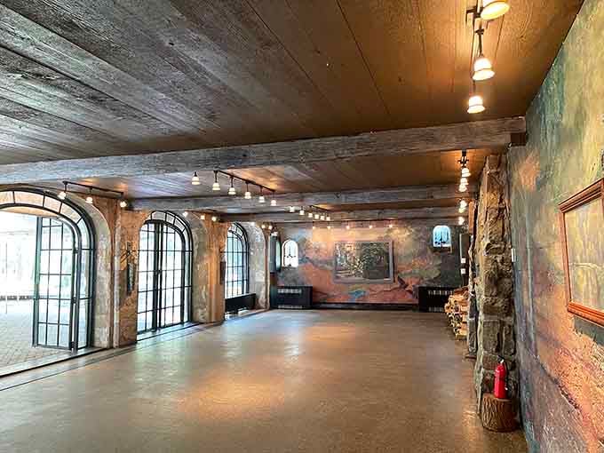 Inside, arched windows and exposed stone create a ballroom that makes your living room look tragically ordinary.
