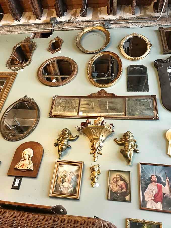 Vintage mirrors and ornate frames cover the walls like a Victorian-era Pinterest board brought magnificently to life.