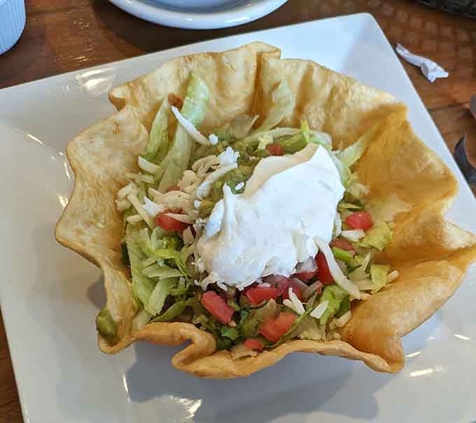 A taco salad in a fried shell is basically a salad wearing a party dress, and we're here for it.