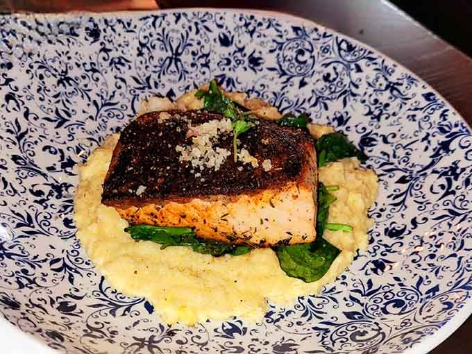 Blackened salmon perched on creamy risotto with wilted greens is comfort food that happens to be elegant.