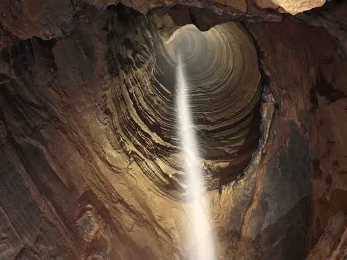 A beam of light pierces the darkness, guiding cavers through one of America's most spectacular underground descents.