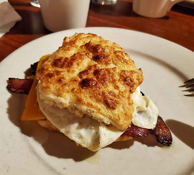 A flaky biscuit sandwich stacked so high it defies the laws of physics and possibly good table manners.