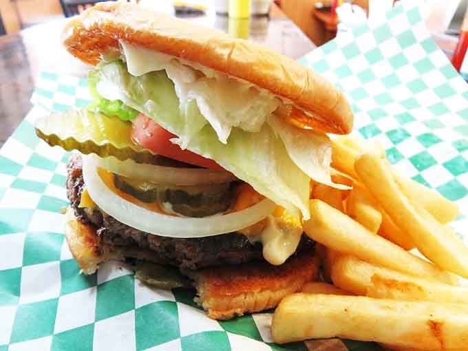 This burger stacks up like a delicious architectural achievement, complete with crispy fries as the foundation.