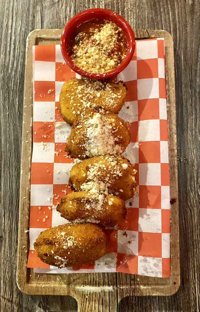 Golden-fried mozzarella balls that could make a grown adult weep with joy, served with marinara for maximum happiness.