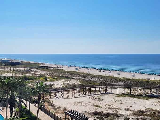 Turquoise water meeting white sand under blue skies, because sometimes Alabama does the Caribbean better than the Caribbean.
