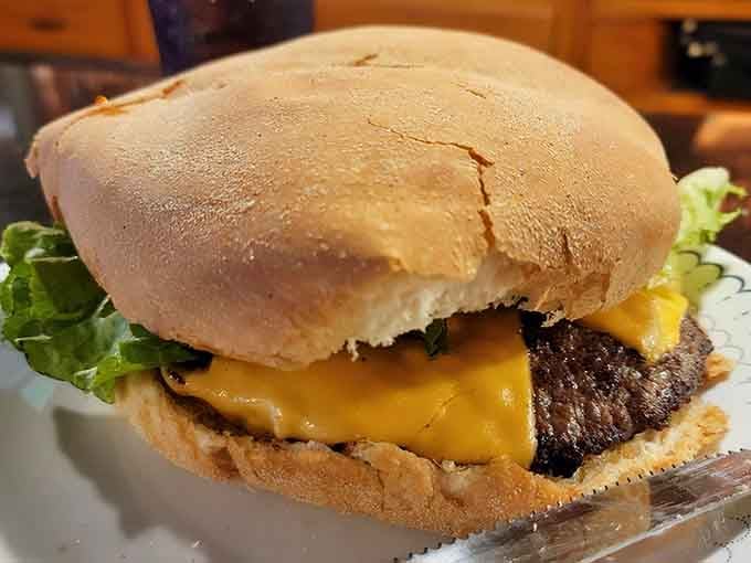 That golden cheese blanket draped over a massive patty is basically what happiness looks like on a plate.