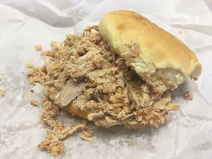 Sometimes the most beautiful things in life are simple: tender pulled pork overflowing from a soft bun, no frills needed.