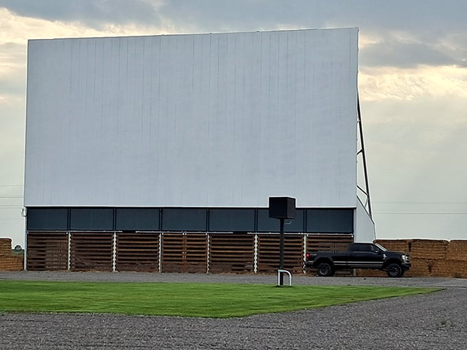 The screen stands ready for showtime while mountains frame the distance like Hollywood's best backdrop could never match.