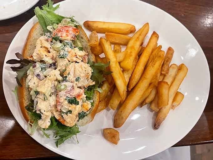 The lobster roll arrives overflowing with sweet meat, making you question why you ever ordered anything else.
