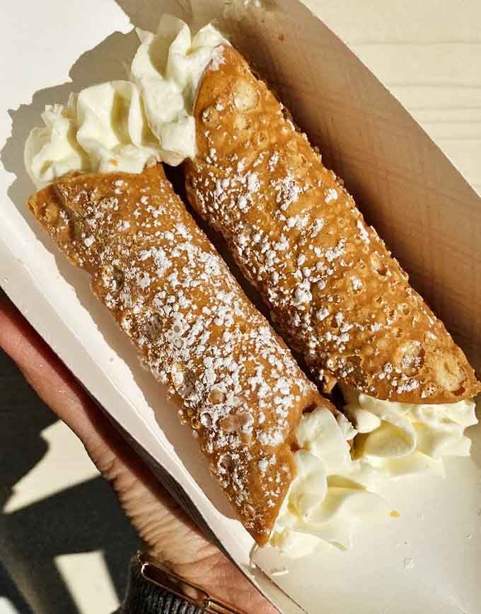 Golden cannoli dusted with powdered sugar and filled with sweet ricotta cream, because sometimes dessert can't wait until after dinner.