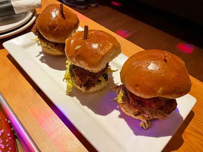 Three spicy chicken sliders lined up like edible bowling pins, ready to knock your taste buds into next week.