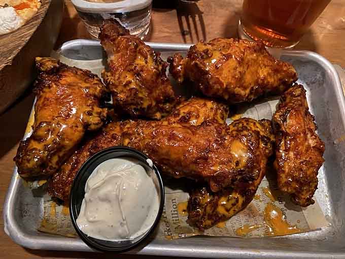 Golden-glazed wings glistening on that metal tray look like they'd make Colonel Sanders himself a little jealous, honestly.