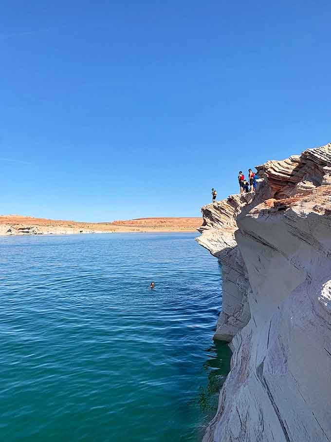 Some people collect stamps; these folks collect memories by leaping into crystal-clear Lake Powell waters.