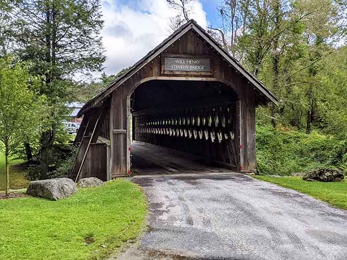 This covered bridge whispers stories of simpler times while framing views that belong on greeting cards.