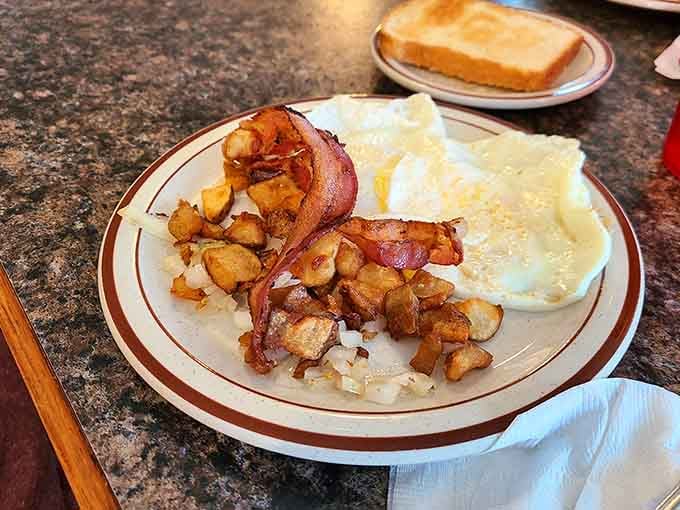 Crispy bacon, perfectly cooked eggs, and golden hash browns create the breakfast trifecta we all deserve.