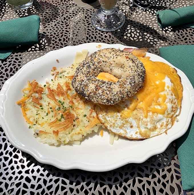 Everything bagel meets fried egg perfection in this architectural marvel that somehow stays together long enough to devour completely.