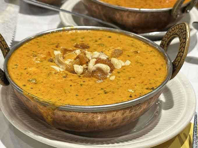 Matar paneer in traditional copper serving dishes, because presentation matters when the food tastes this incredible.