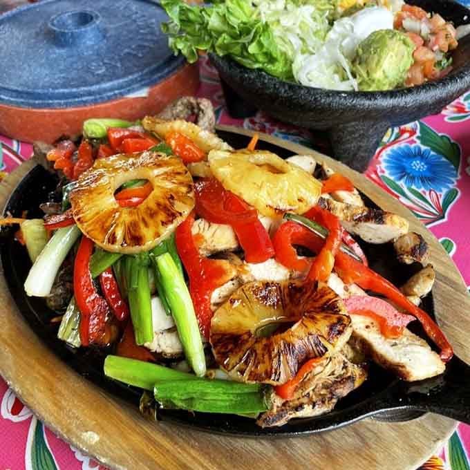 Sizzling fajitas with grilled pineapple bring the luau straight to your table, no grass skirt required here.