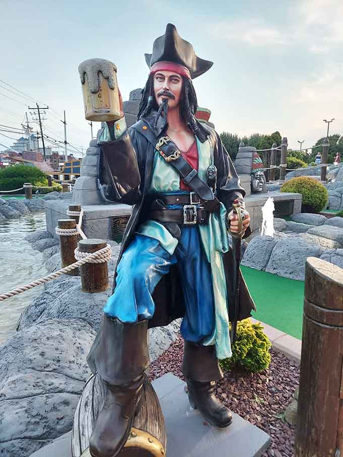 A life-sized pirate statue guards the course, silently judging your putting skills with his permanent smirk.