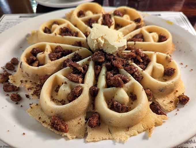 This waffle topped with candied pecans and whipped cream is basically dessert pretending to be breakfast, and we're okay with that.