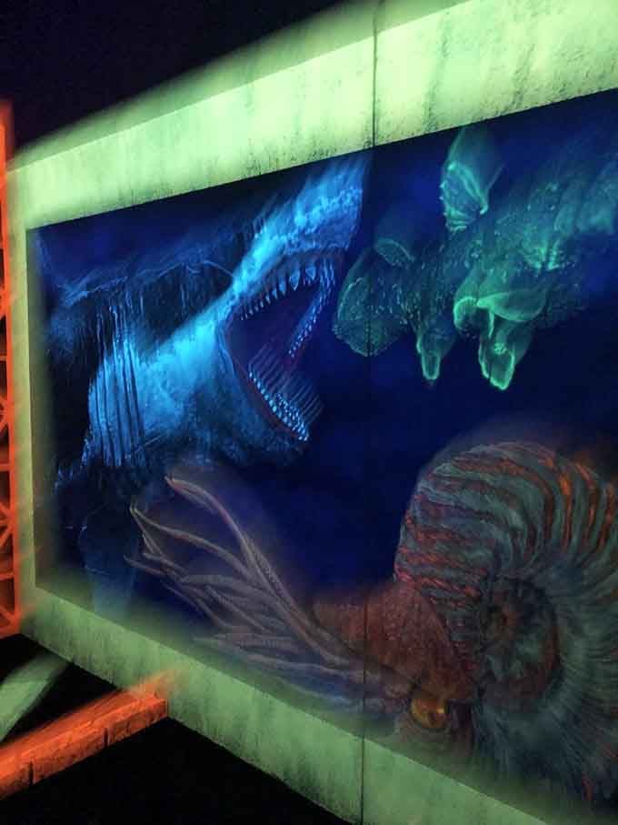 Prehistoric sea creatures lurk in glowing blue depths, proving the ocean was terrifying long before Jaws.